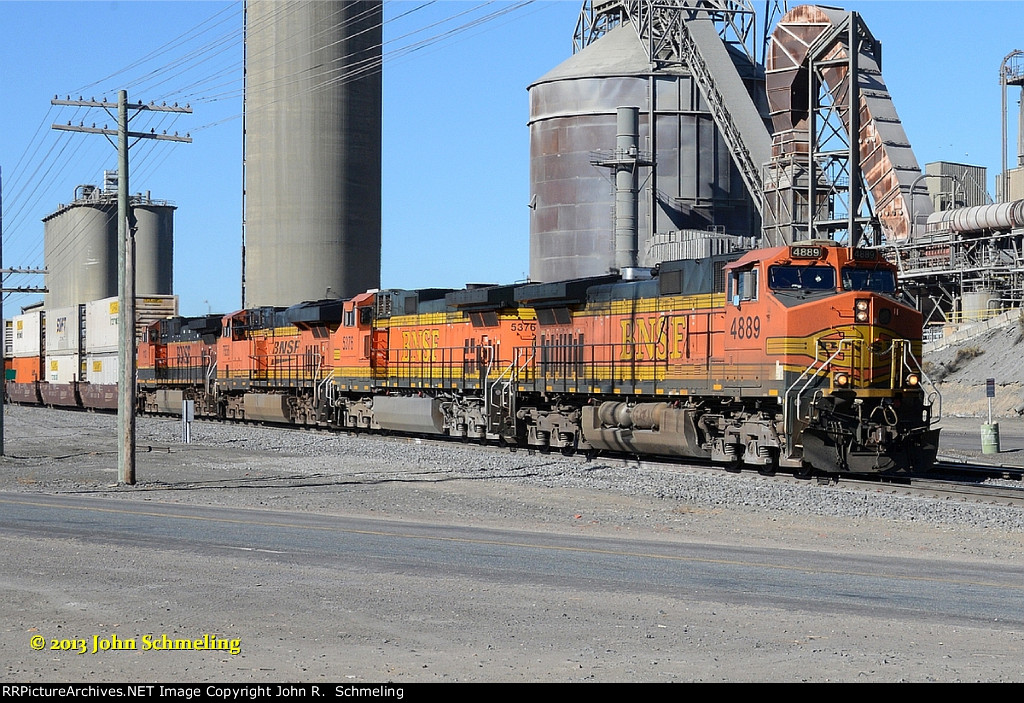 BNSF 4889 (C44-9W) along with three more Dash 9's the last one in H1 paint hustle this stack ...